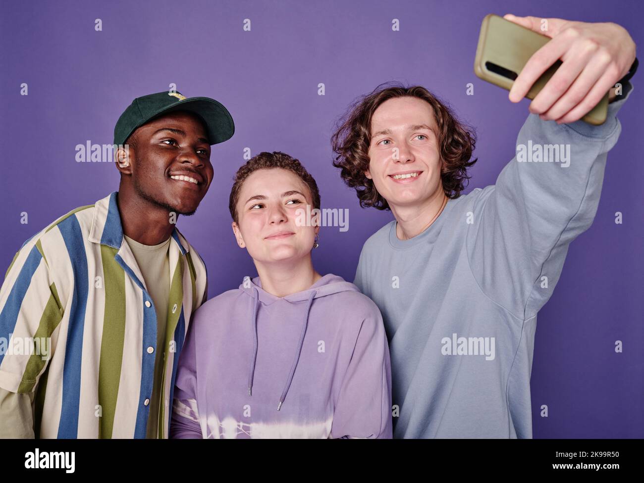 Group of students making selfie portrait on smartphone standing against ...