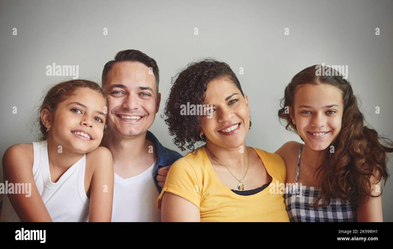 Family is what matters most. Portrait of a happy young family spending quality time together ...