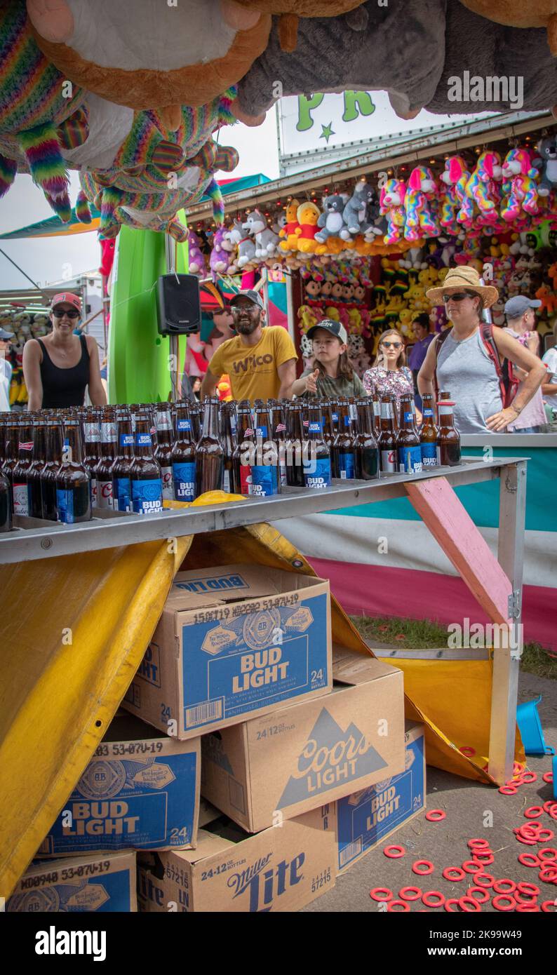 A family enjoying a country fair playing games Stock Photo - Alamy