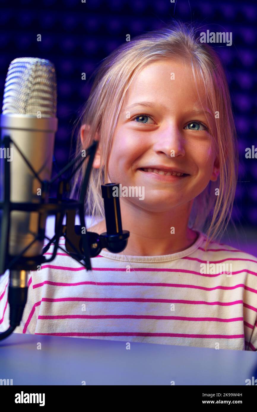 Smiling child girl sitting in recording studio portrait Stock Photo - Alamy