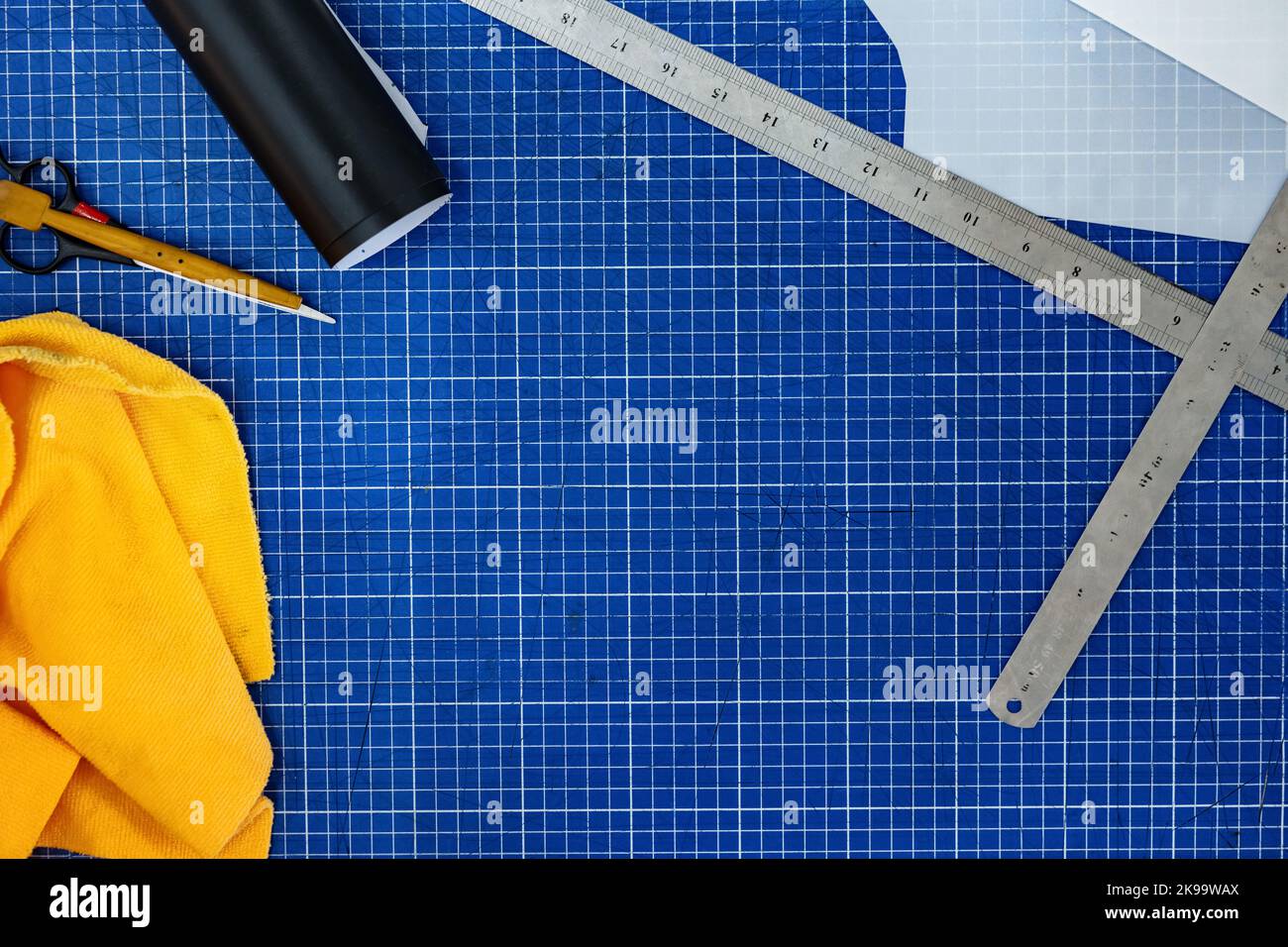 Desktop top view with blue cutting mat Stock Photo - Alamy