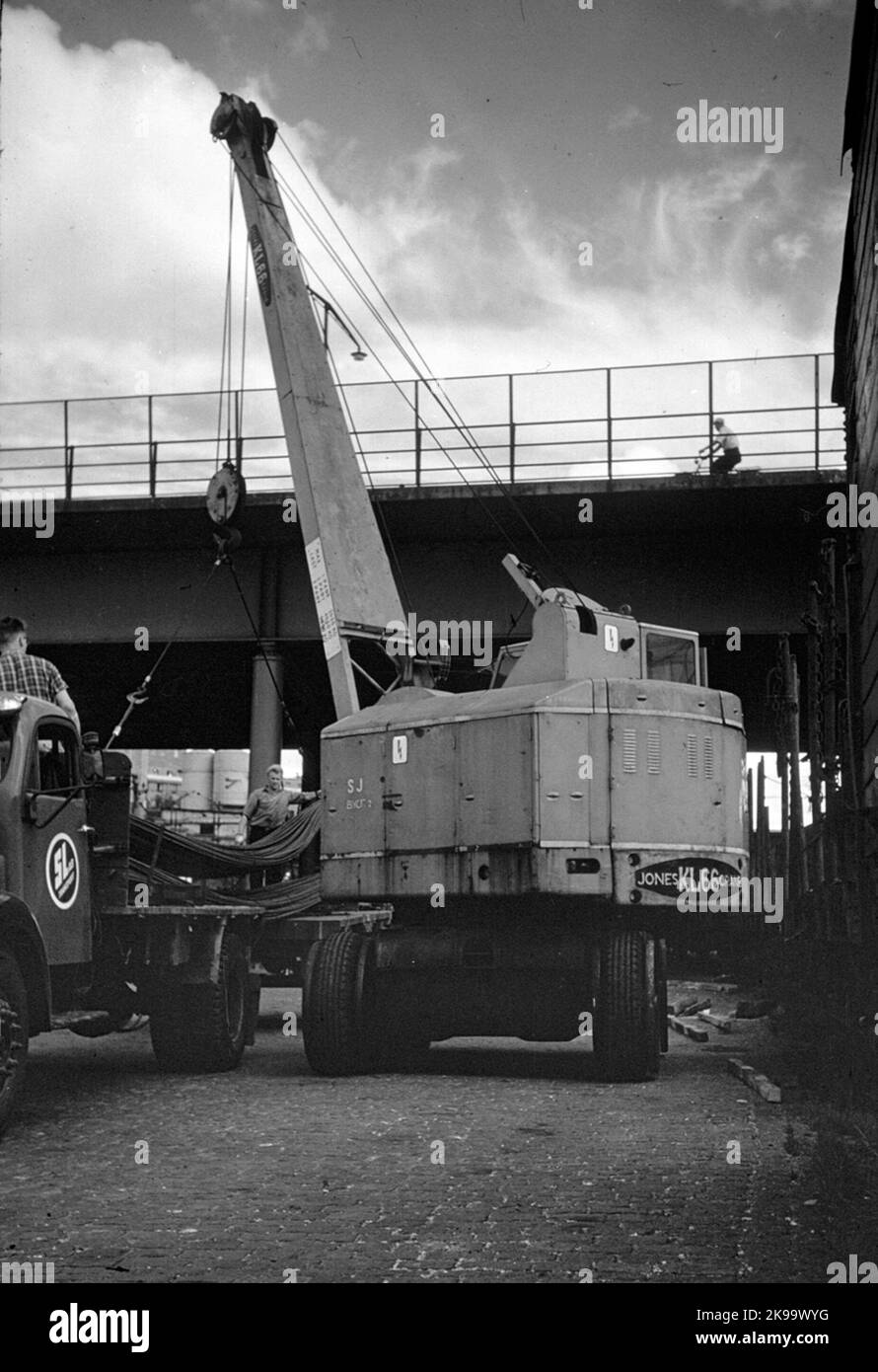 Construction work crane loading Black and White Stock Photos & Images ...