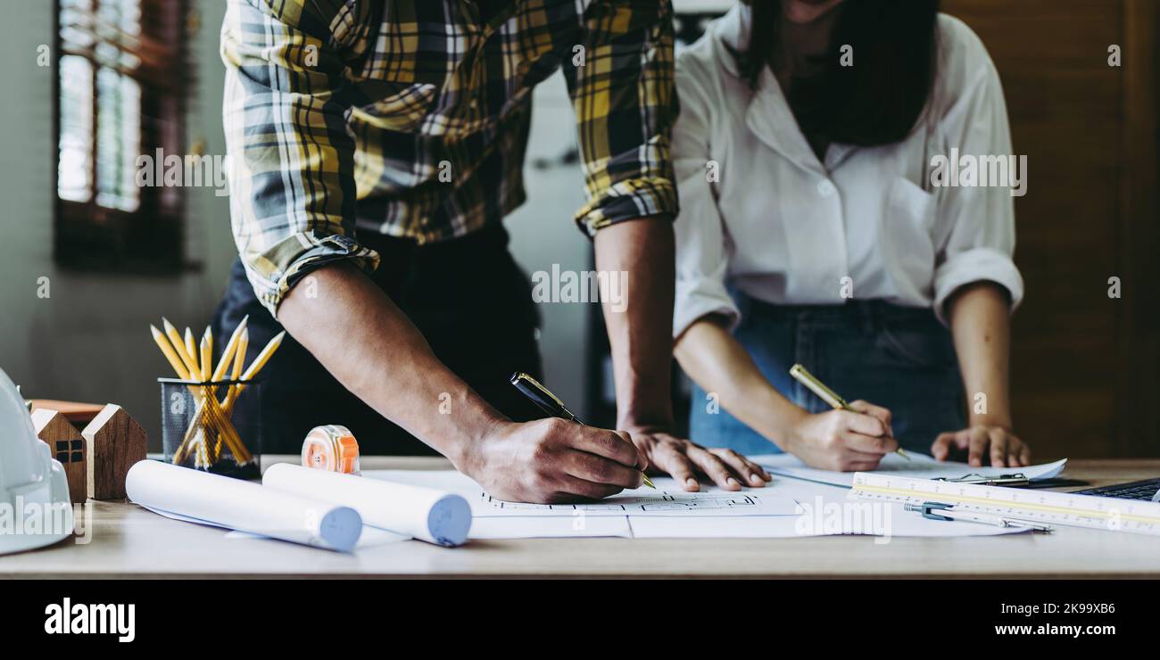 Architect man working with blueprints for architectural plan, engineer ...
