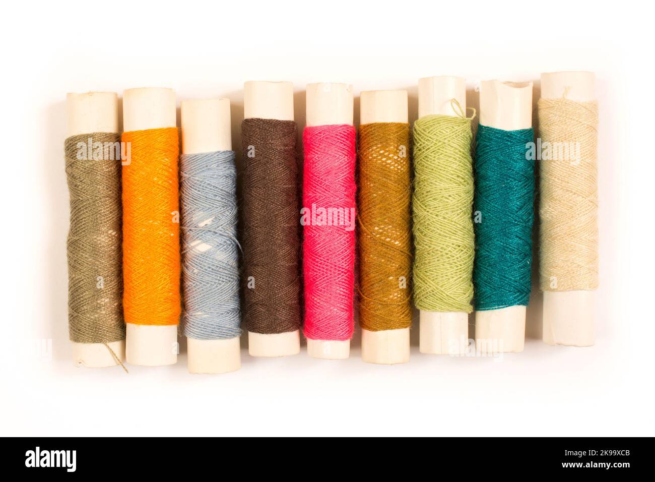 Colorful cotton yarns on rolls for sewing. Thread spools used in fabric ...