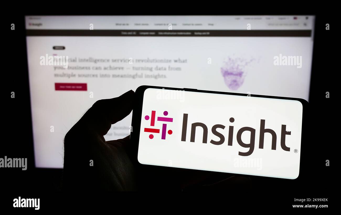 Person holding mobile phone with logo of American company Insight ...