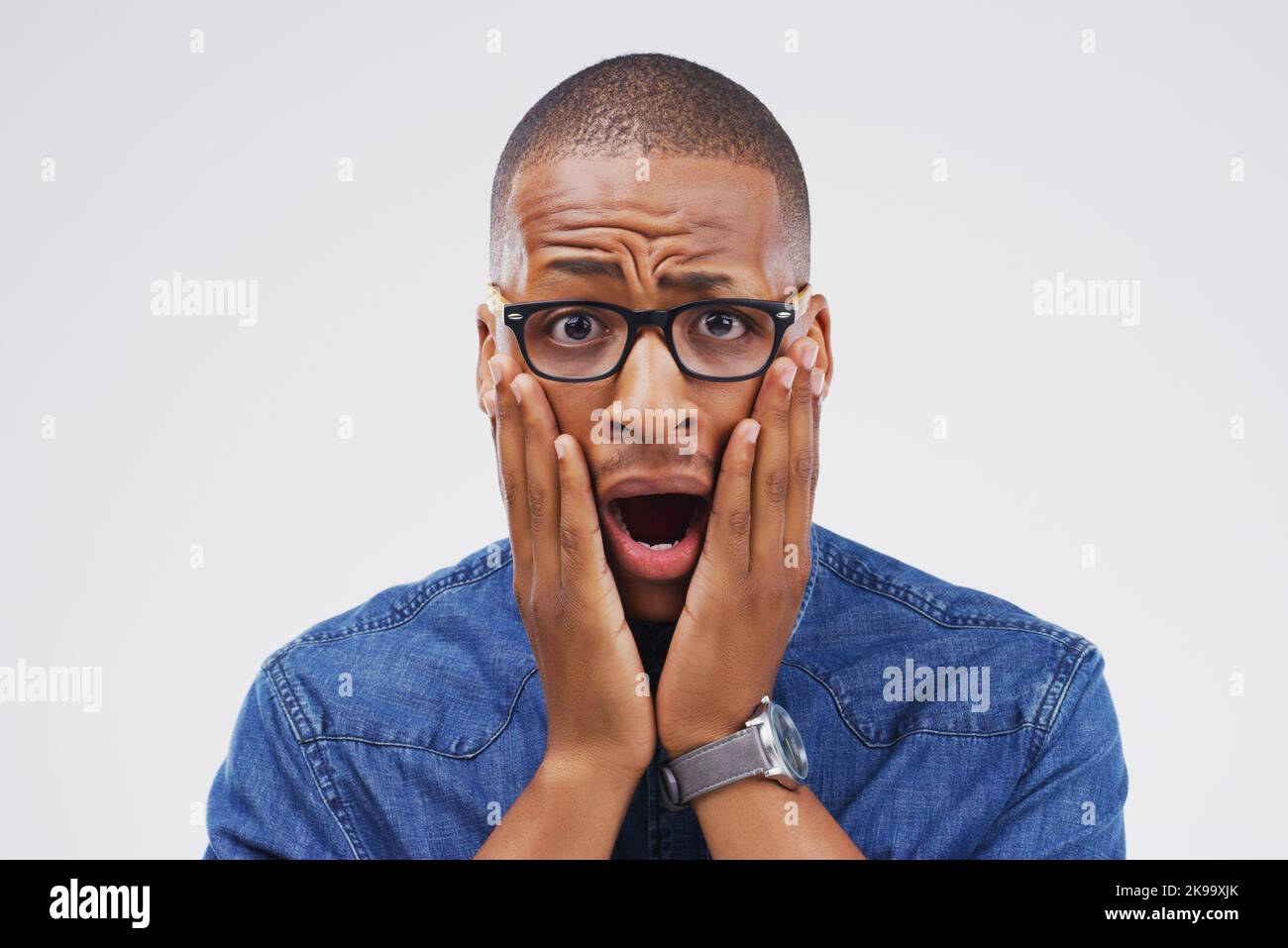 I am shook. Studio shot of a young man looking shocked against a grey ...