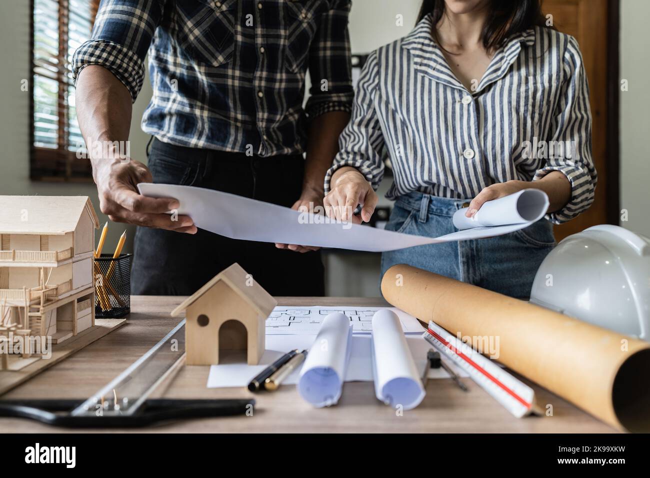 Architect man working with blueprints for architectural plan, engineer ...