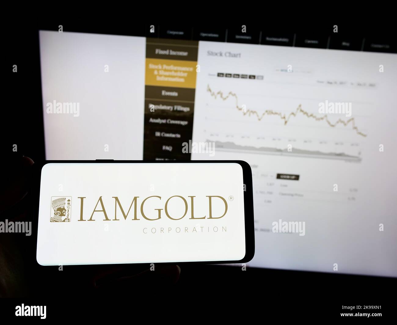 Person holding mobile phone with logo of Canadian mining company ...