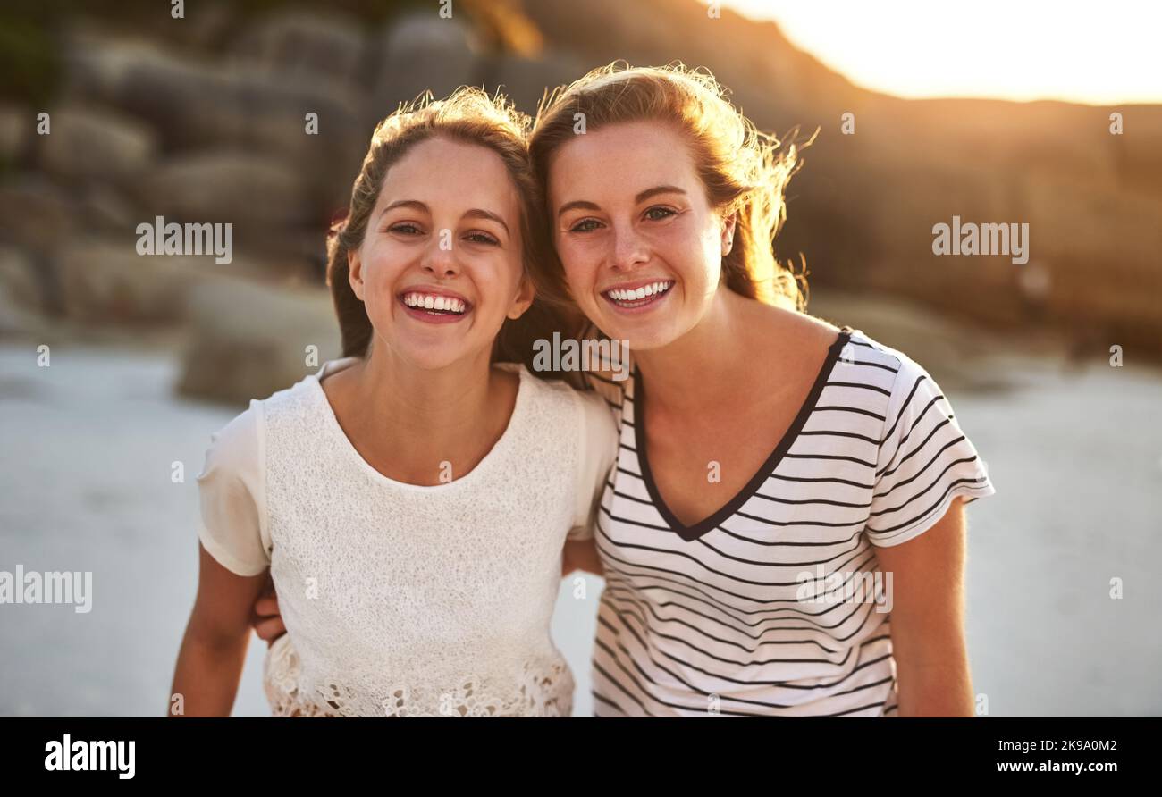 Were inseparable. two friends spending the day at the beach Stock Photo ...