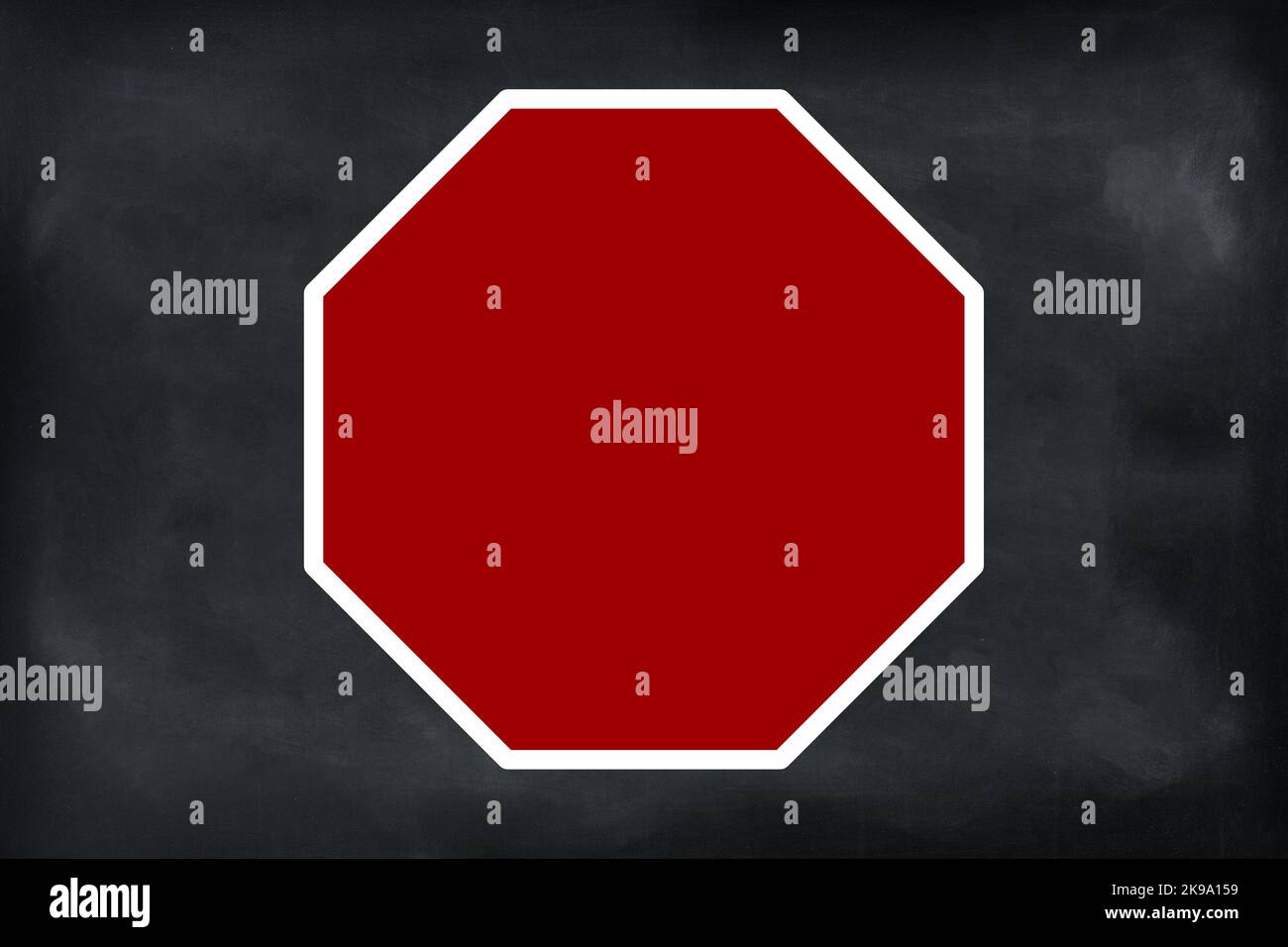 Empty red color stop sign on black chalkboard with copy space for text ...