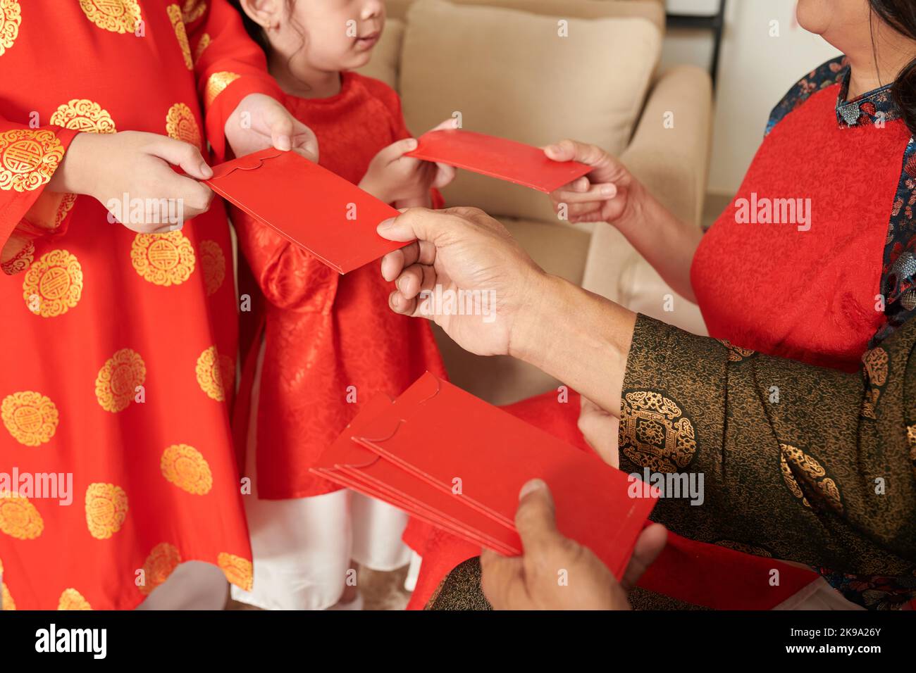 Hands of grandparents gifting lucky money envelopes to children when ...