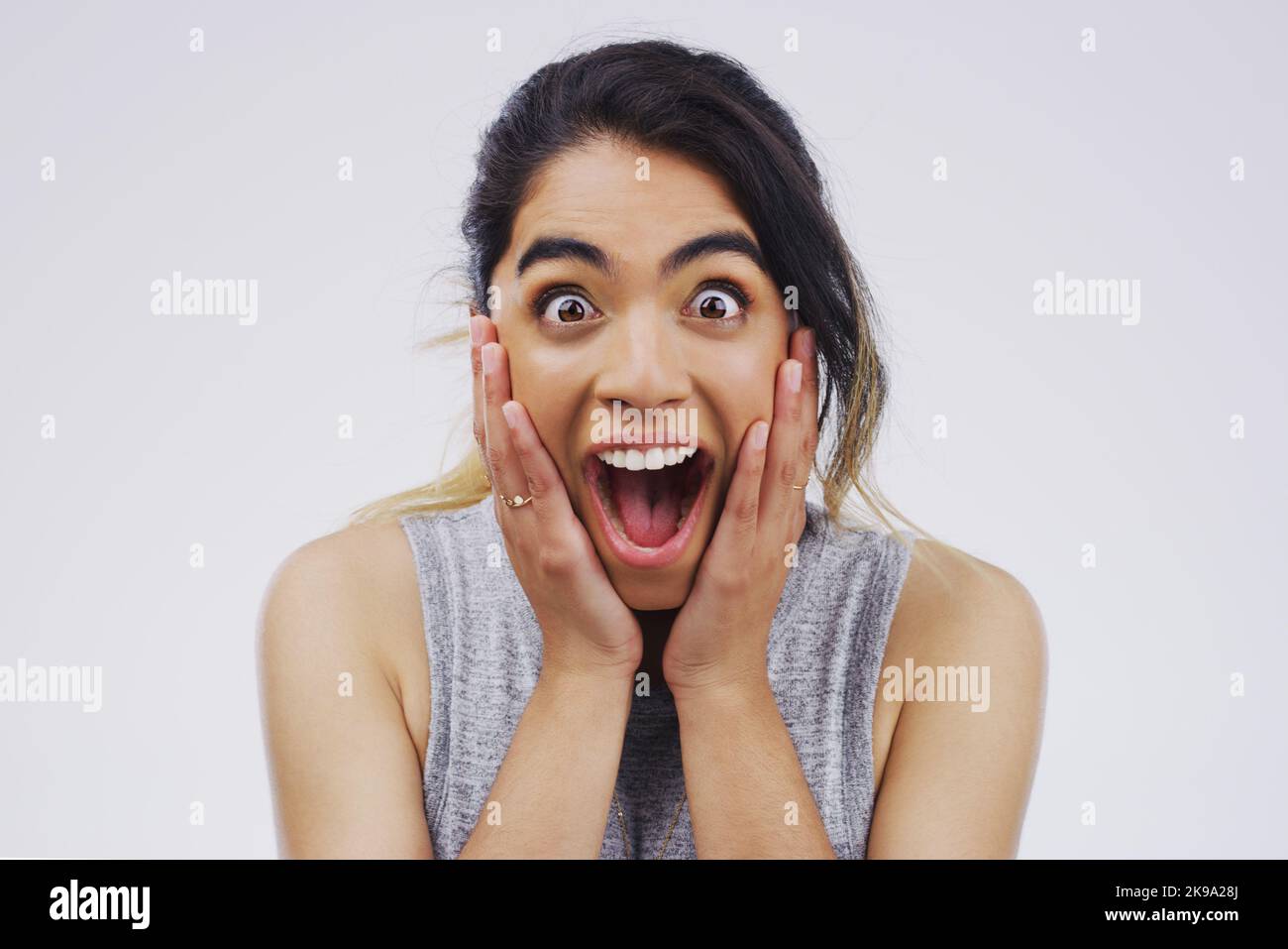 She cant contain her excitement. Studio portrait of an attractive young ...