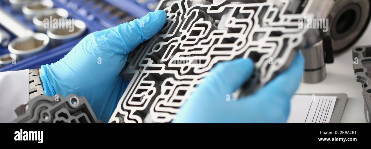 Mechanic man in gloves hold automobile part, shiny new car detail Stock ...