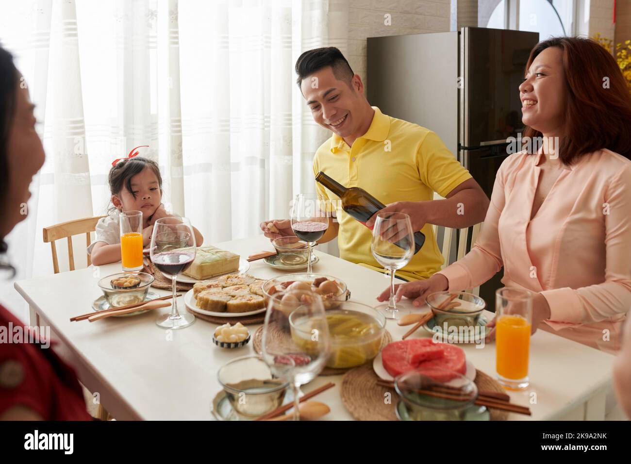 Family celebrating spring festival at home, eating delicious dinner and ...