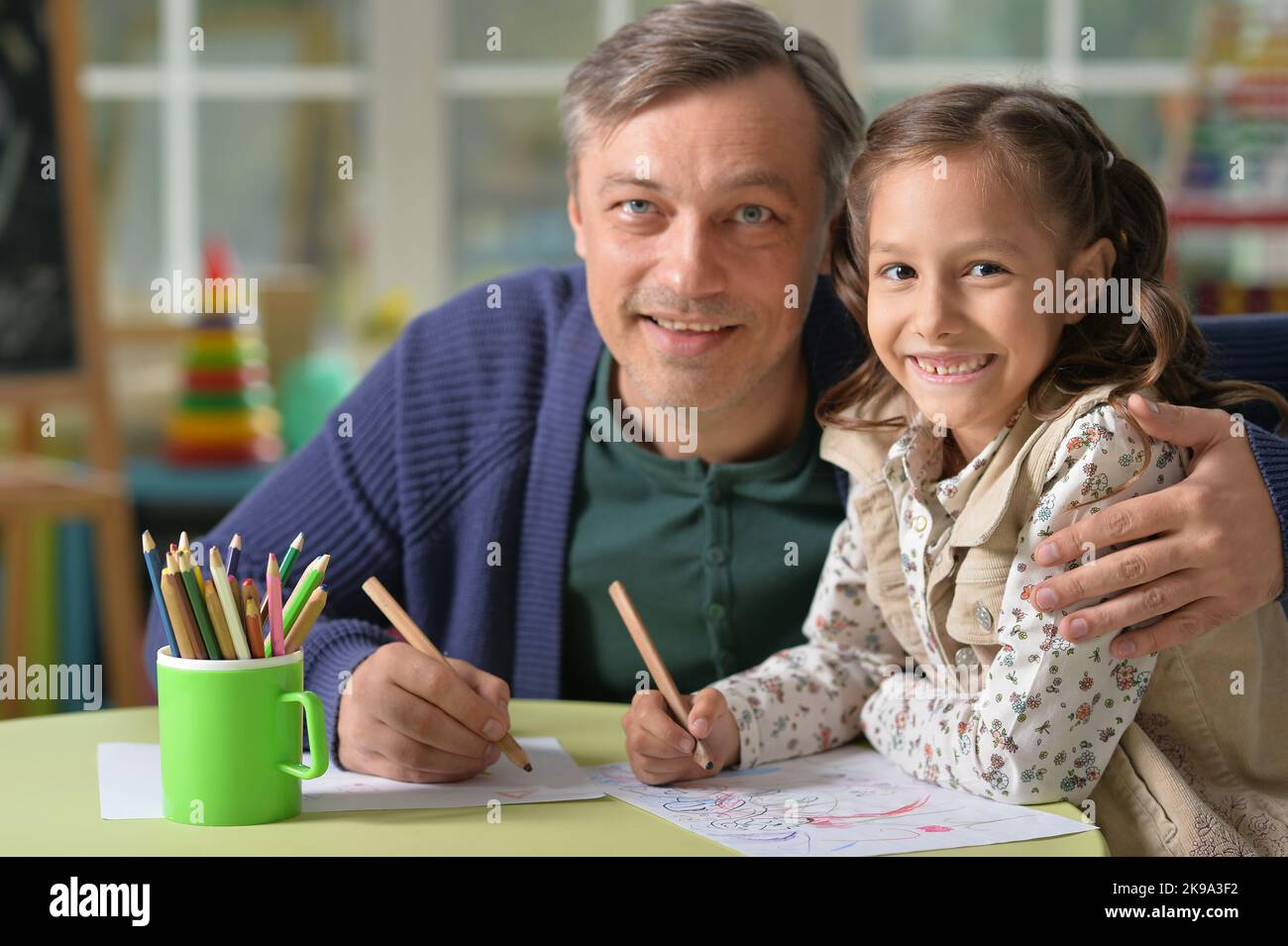 Portrait of father with cute daughter draw Stock Photo - Alamy