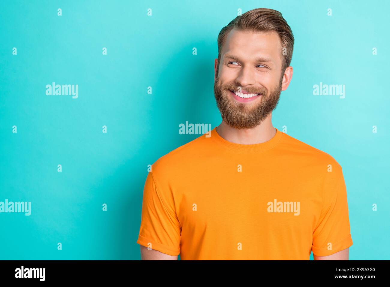 Photo portrait of attractive young man toothy smiling look tricky empty ...