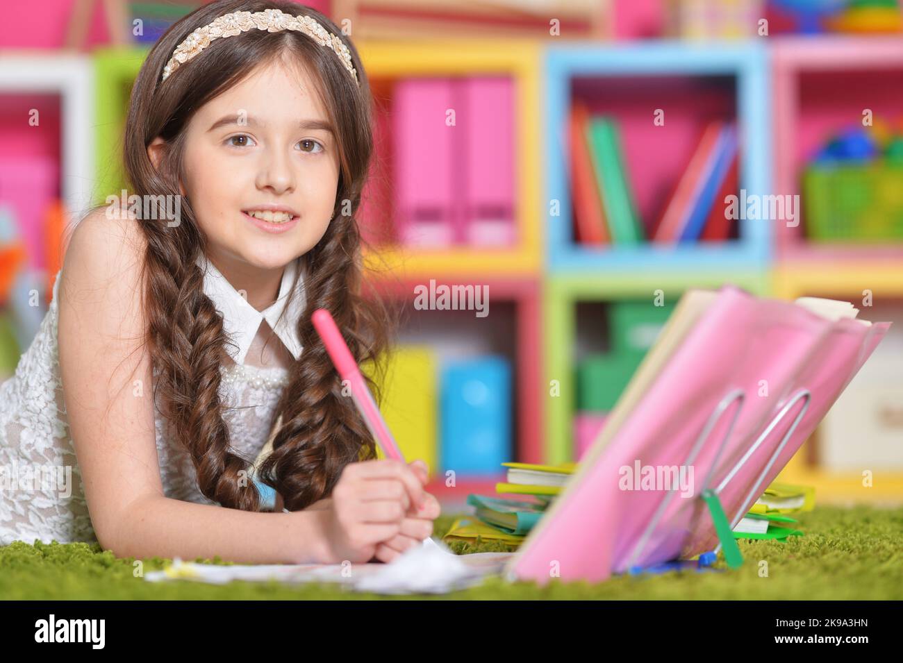 Portrait of cute little girl study at home Stock Photo - Alamy