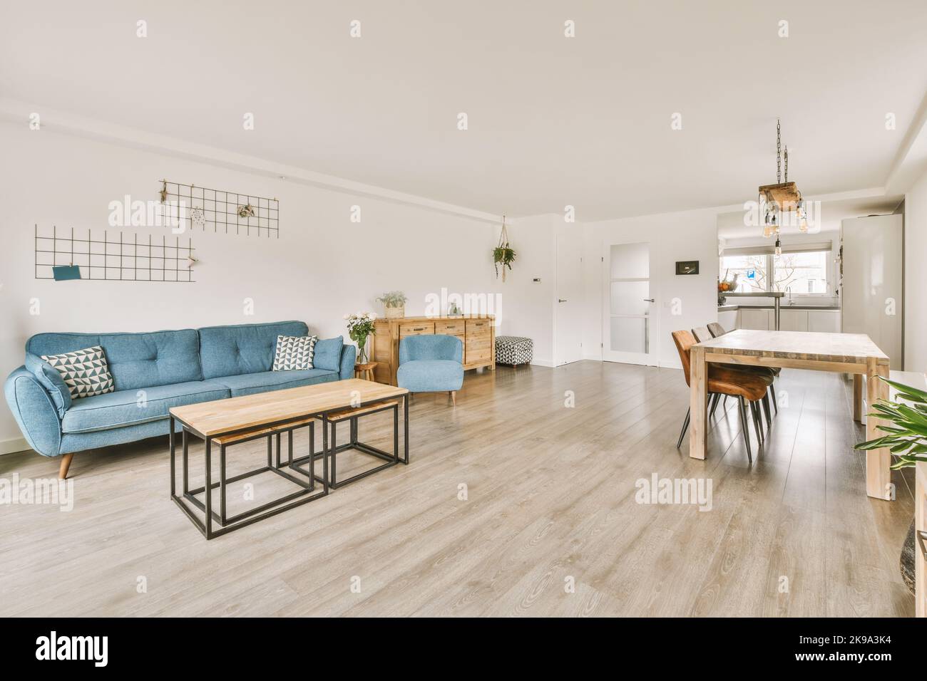 Interior of living room with comfortable sofa and TV against windows in ...