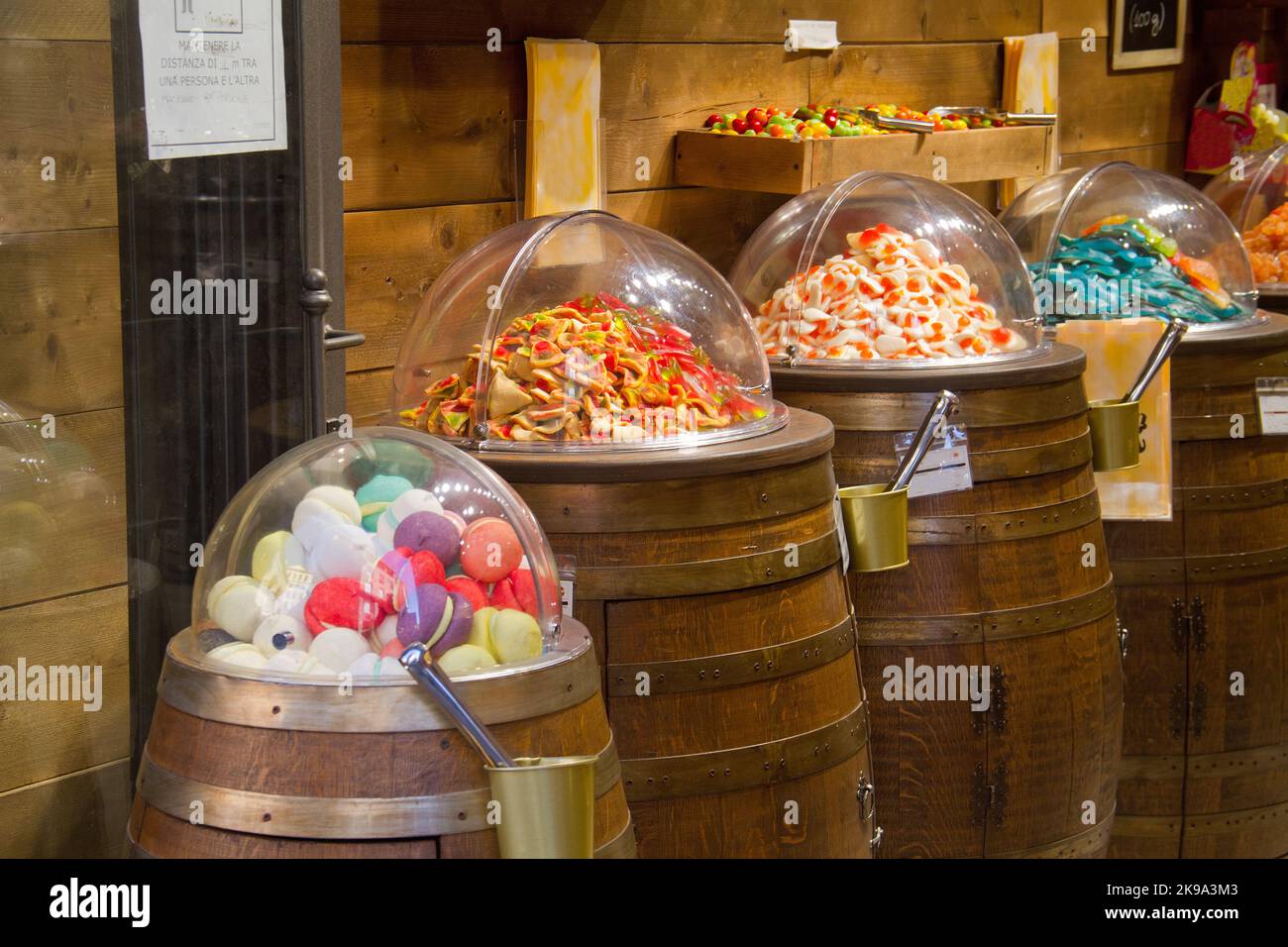 Interior of a candy store, piles of candy displayed under glass domes ...