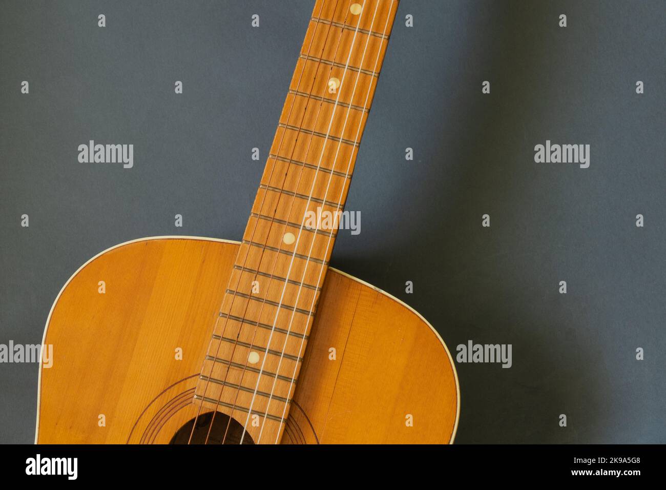 wooden brown guitar on a dark background Stock Photo - Alamy
