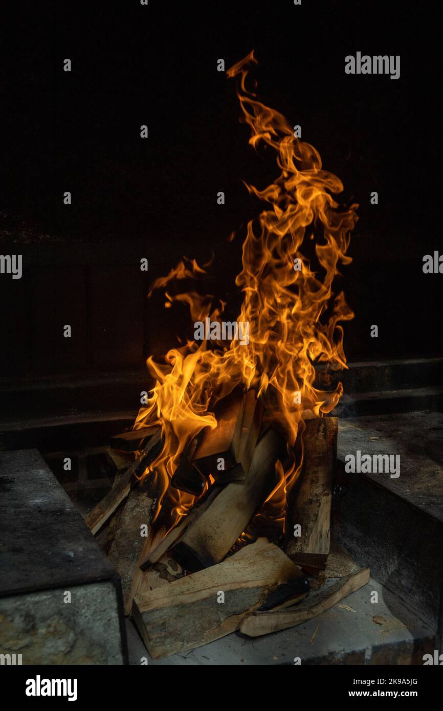 Detail of barbecue or fireplace fire burning pieces of wood in its ...