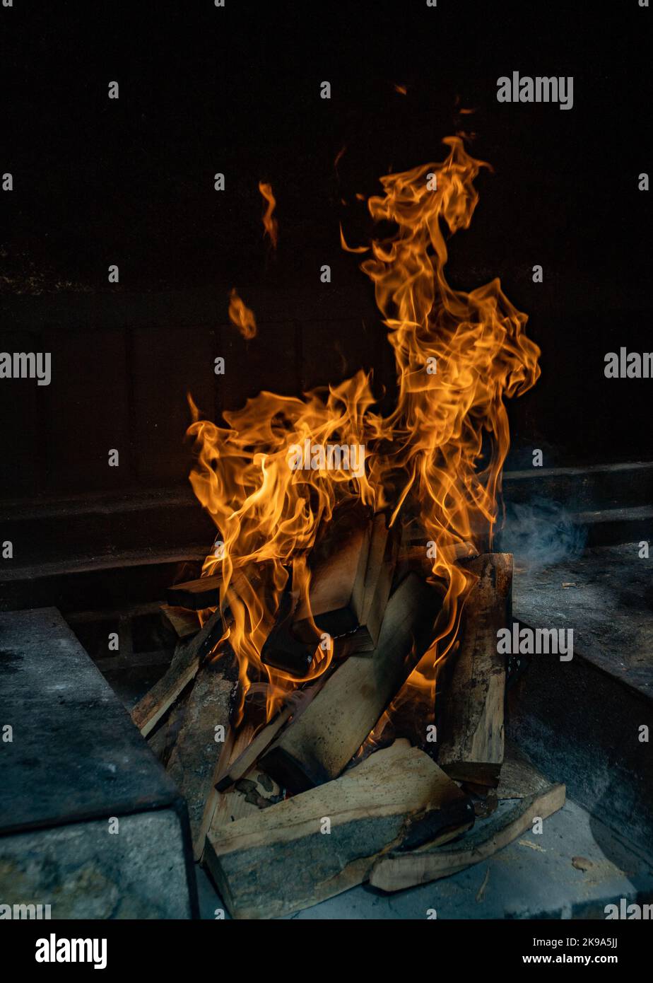 Detail of barbecue or fireplace fire burning pieces of wood in its ...