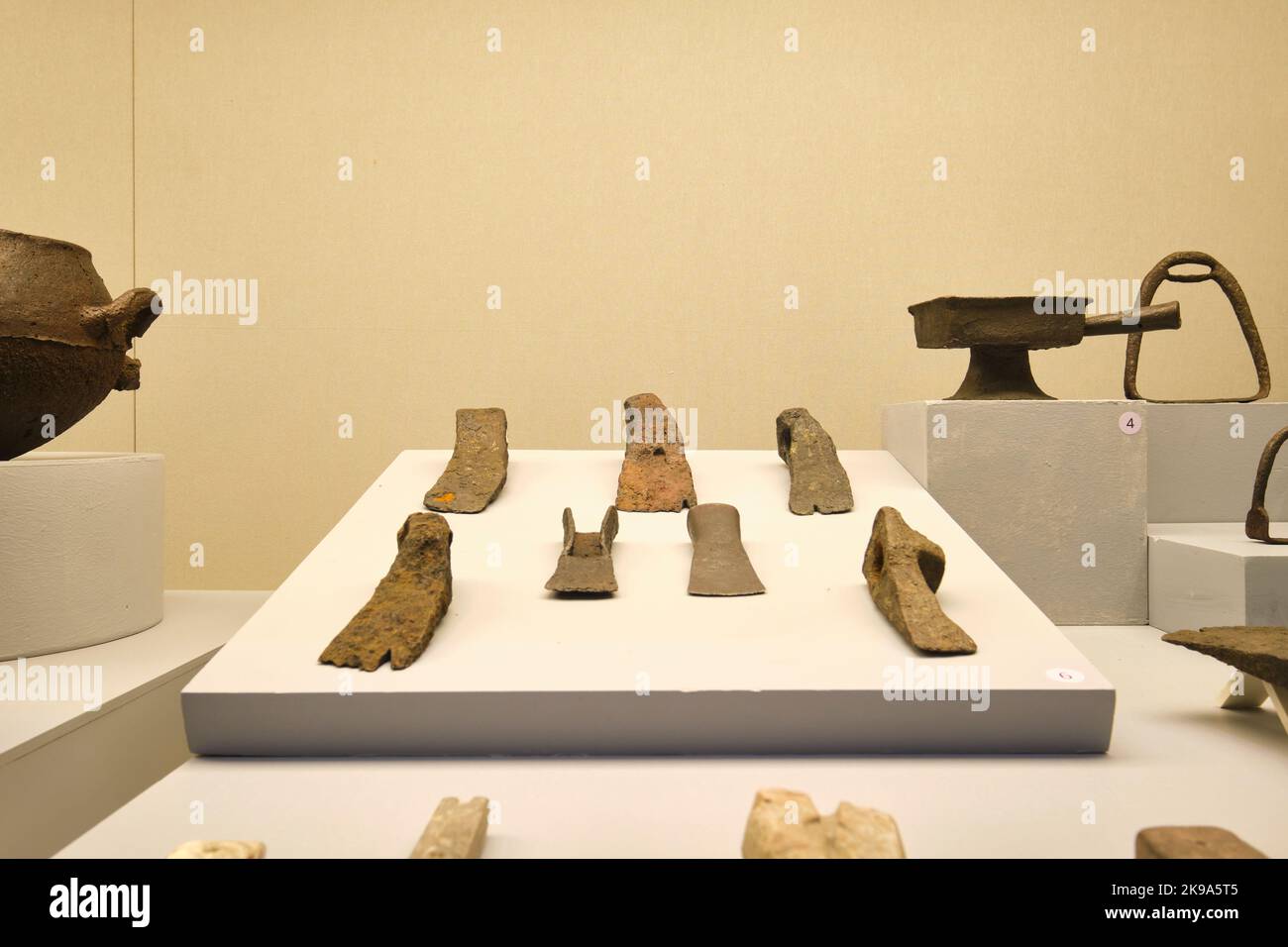 A display of various rusted, metal, steel axe, chisel heads, used for ...