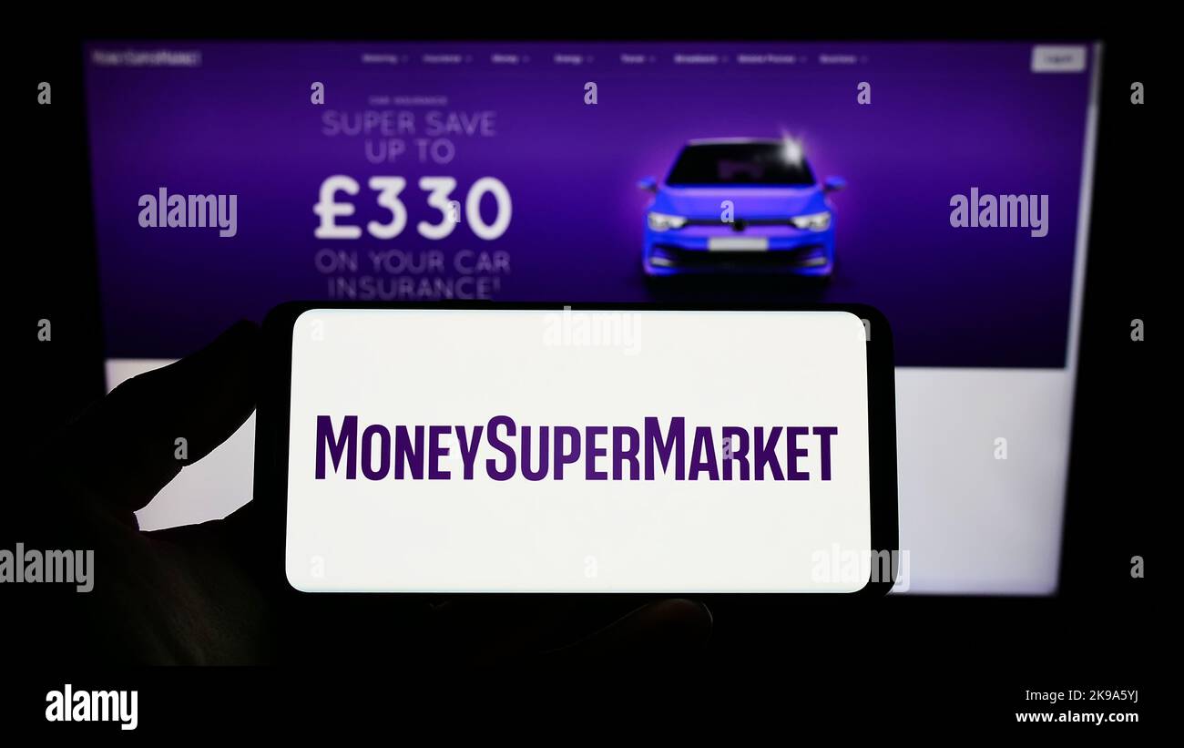 Person holding smartphone with logo of British company Moneysupermarket ...