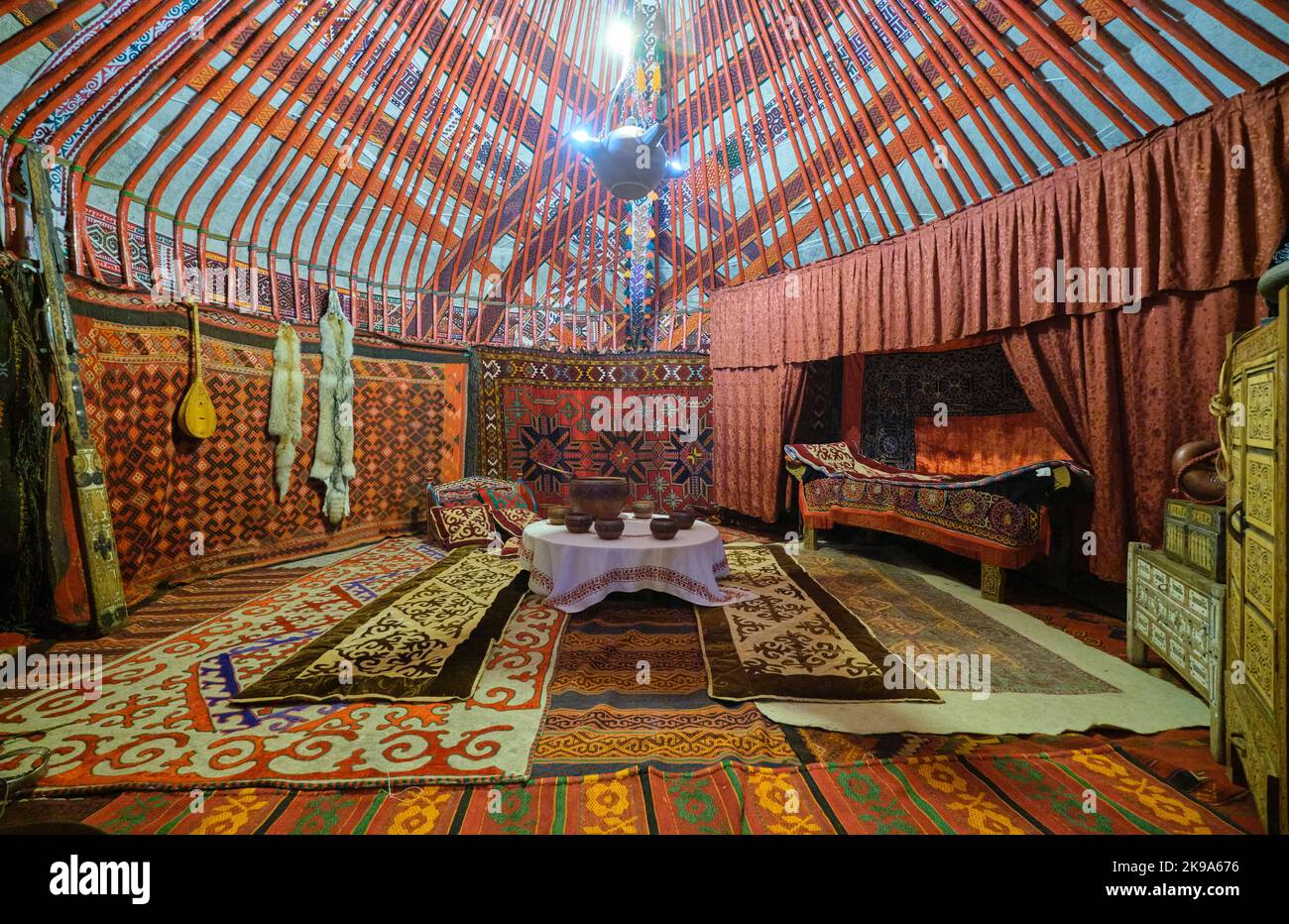 Inside view of a full scale model of a yurt, featuring many rich ...
