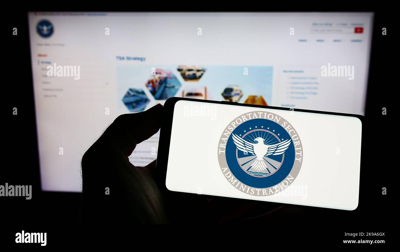 Person holding cellphone with seal of Transportation Security ...