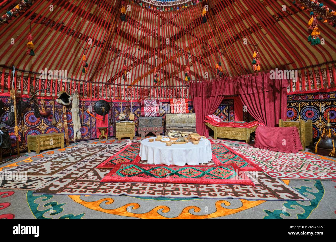 Inside view of a full scale model of a yurt, featuring many rich ...