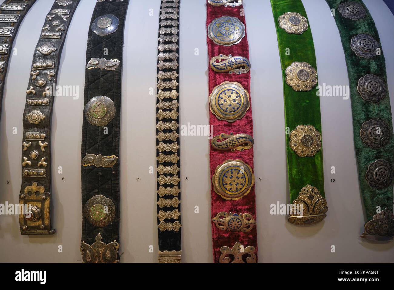 A collection of old, antique, traditional decorated belts, both cloth ...