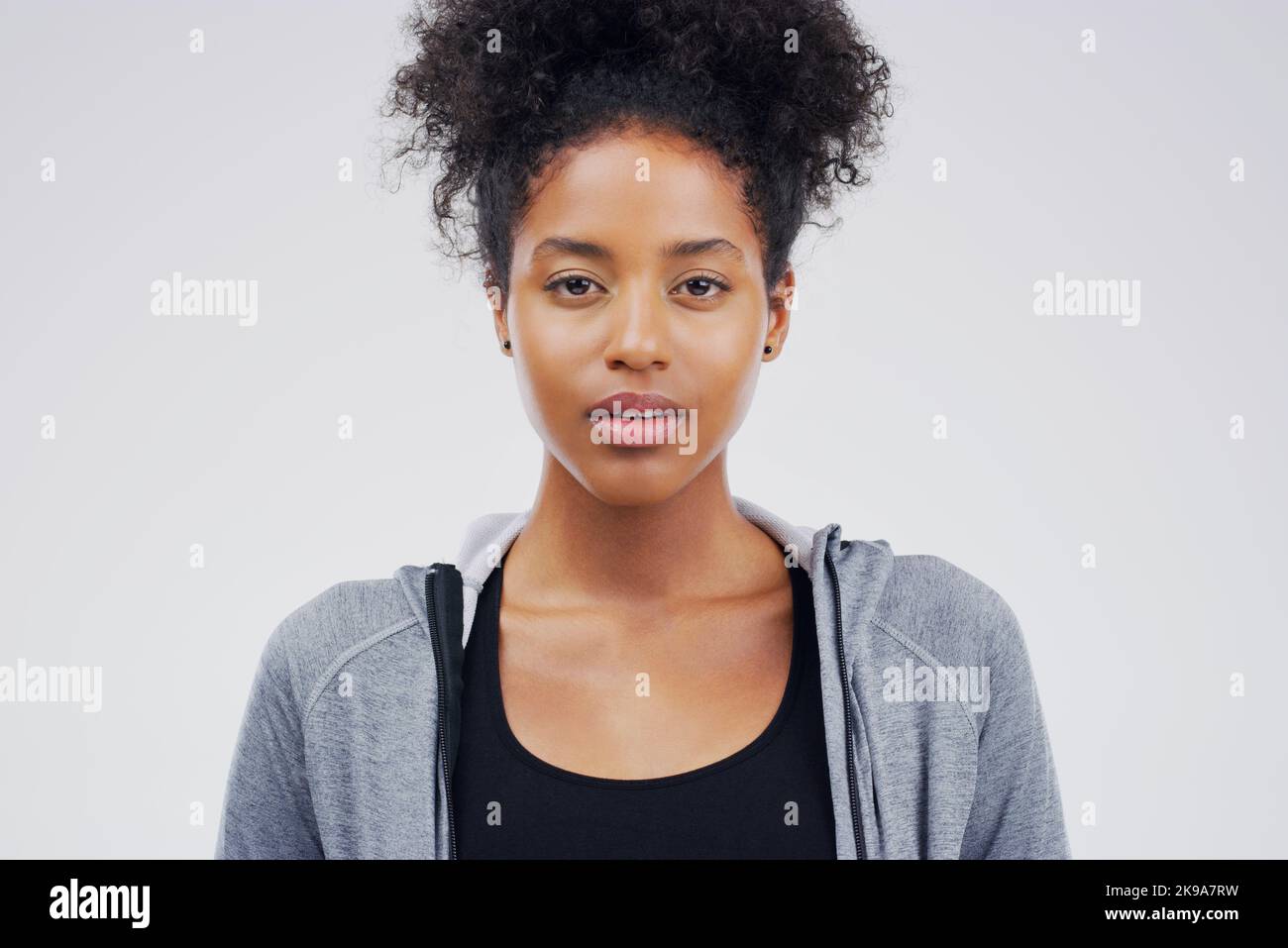 Expressionless. Studio portrait of an attractive young woman posing ...