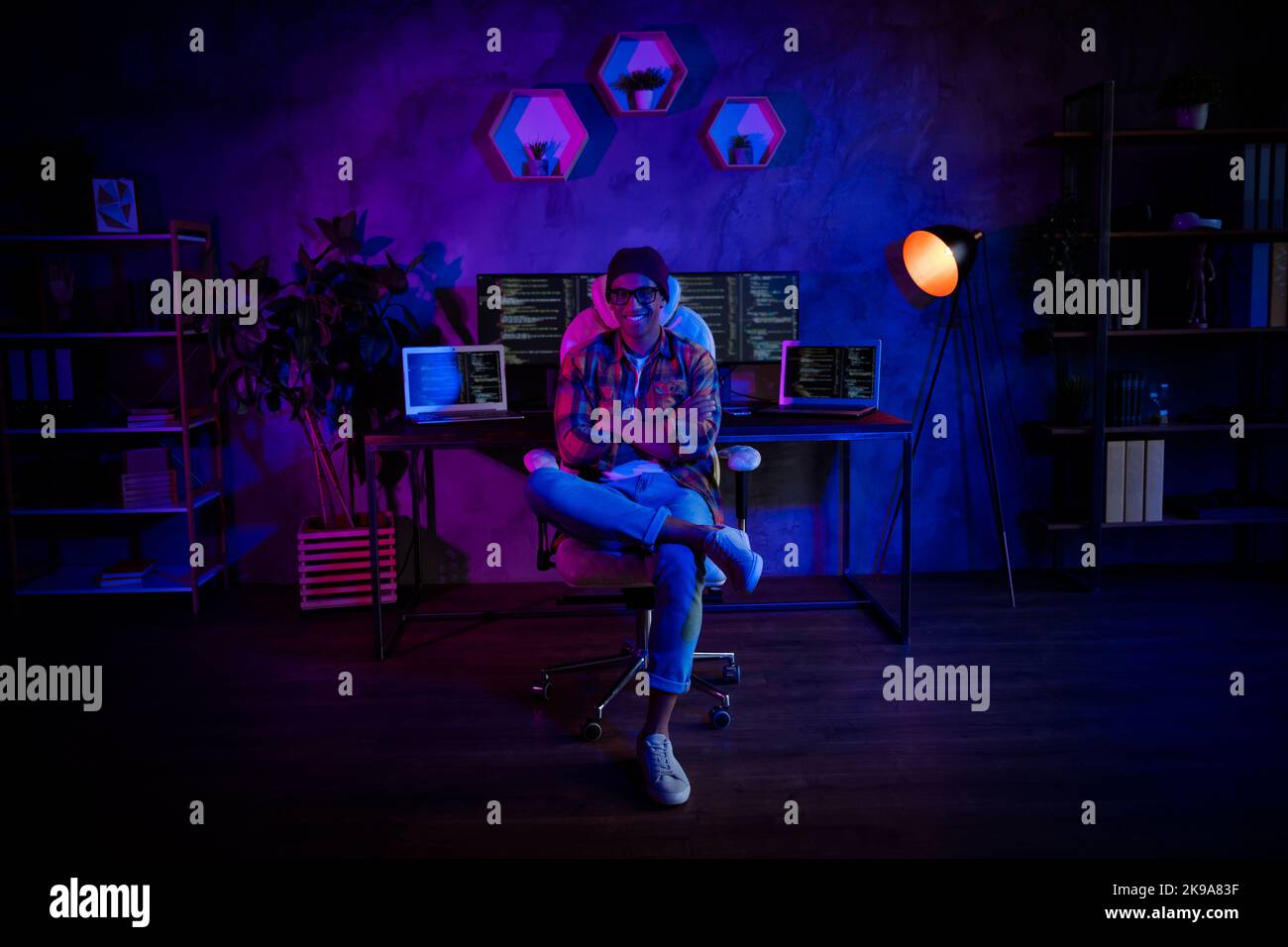 Full body portrait of cheerful professional hacker sitting chair ...