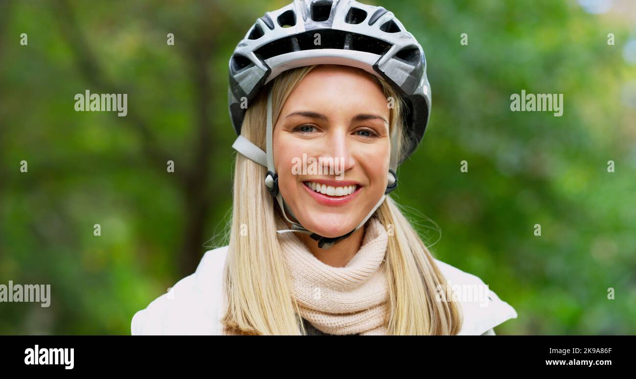Its important to be protected. a cheerful young woman riding her ...