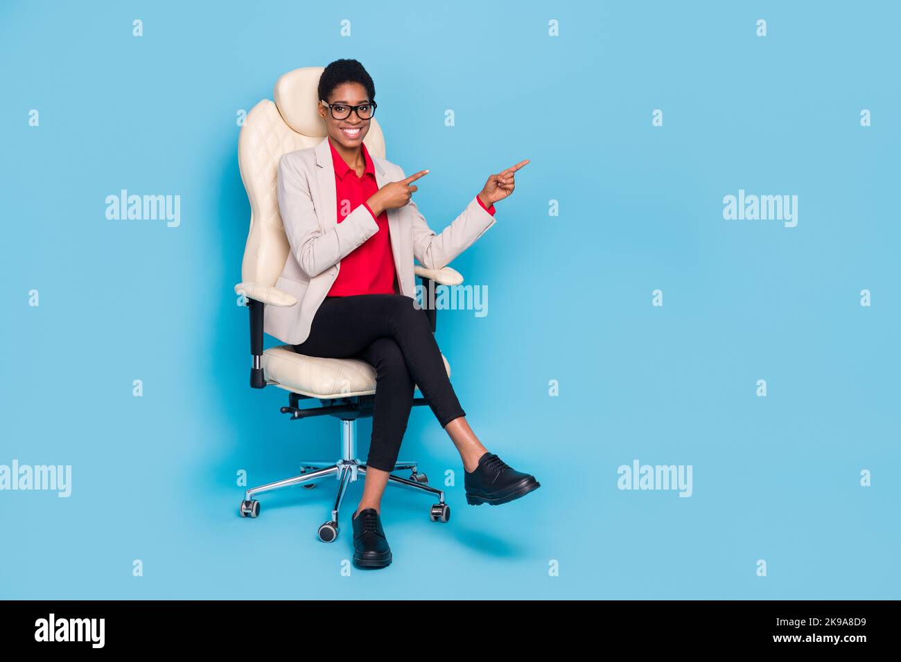 Full body photo of positive person sitting chair indicate finger empty ...