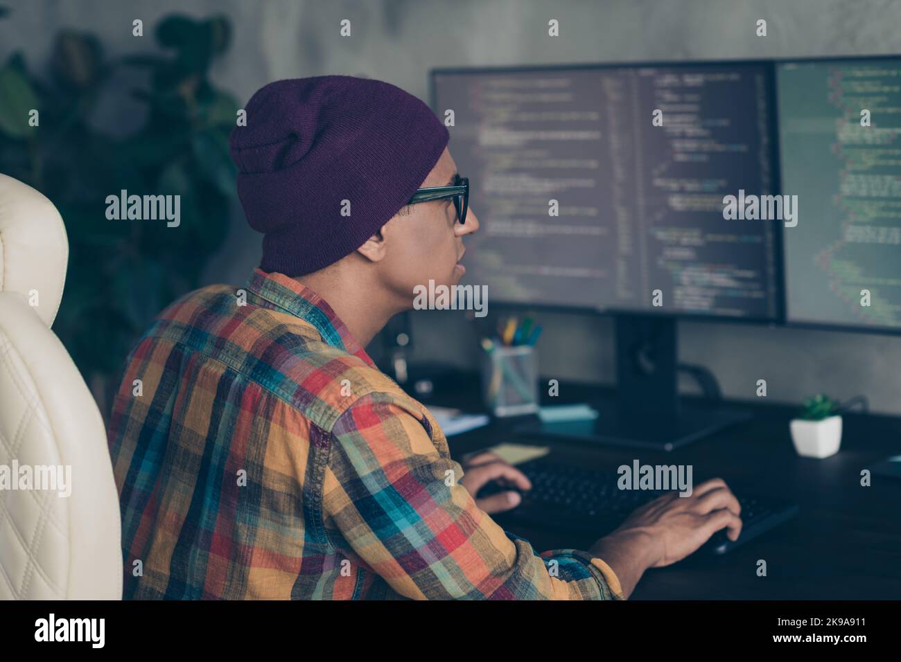 Photo of serious clever programmer wear spectacles hat writing code ...