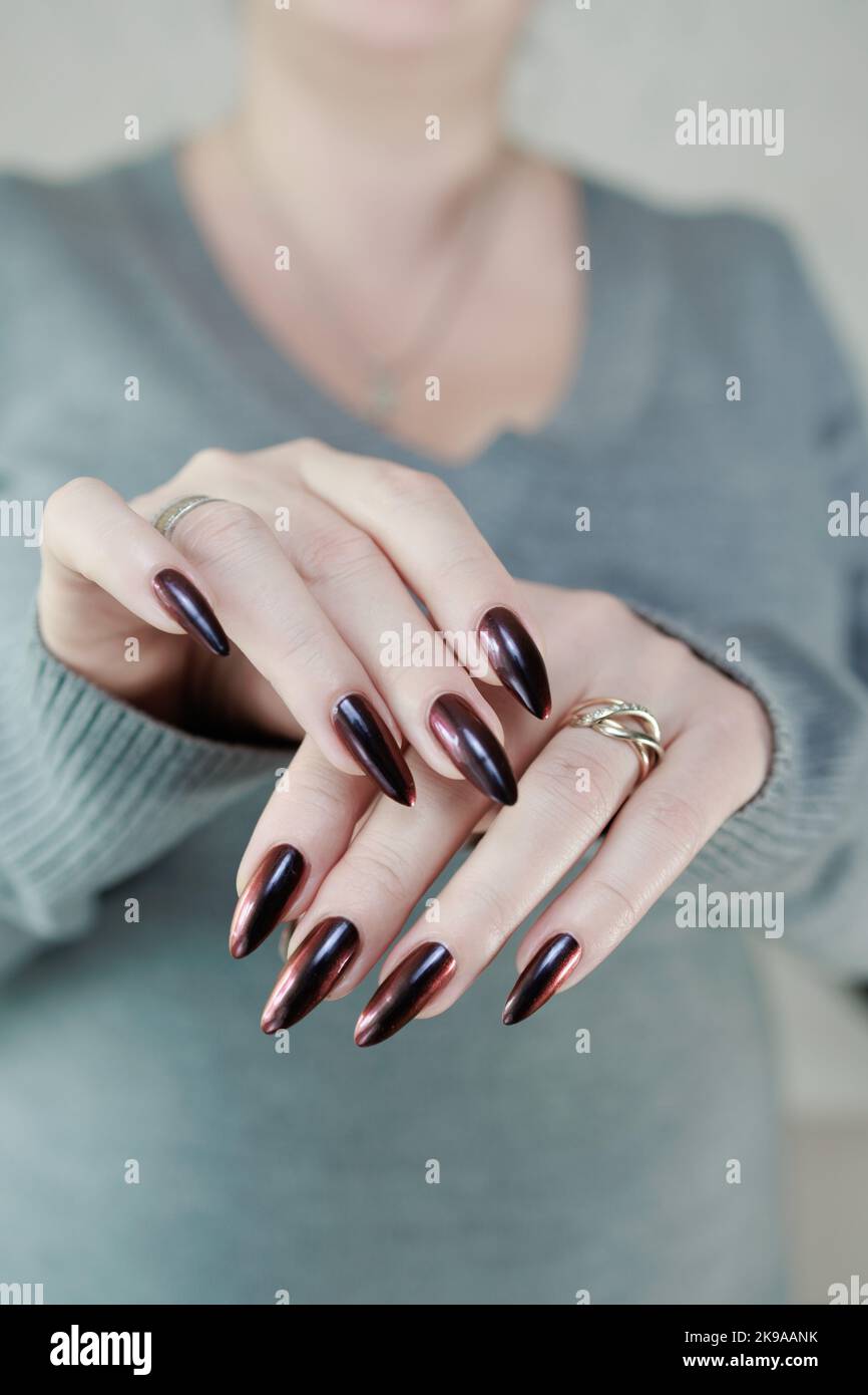 Female hands with long nails and black and red nail polish Stock Photo ...