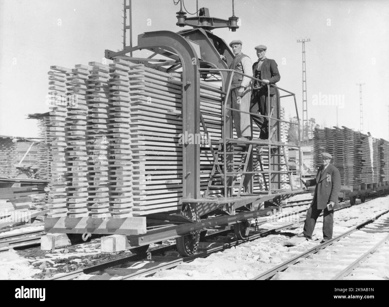The lifting hook for loading wood from trolley Stock Photo - Alamy