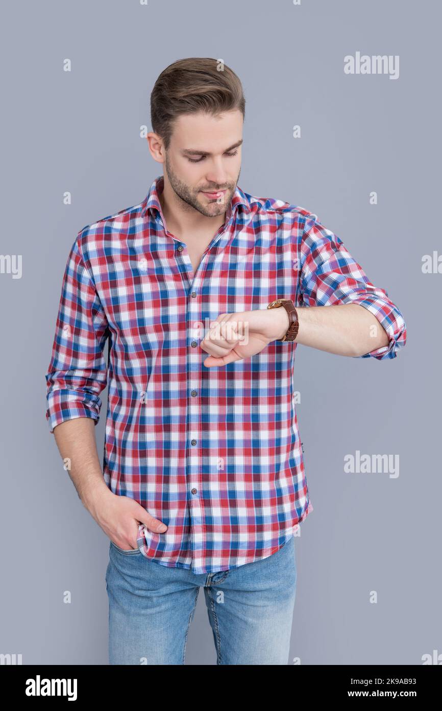 handsome man check time on watch isolated on grey background. man check ...