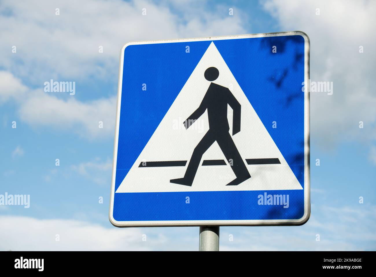 Vertical signage of crosswalk over cloudy sky, road sign pedestrian ...