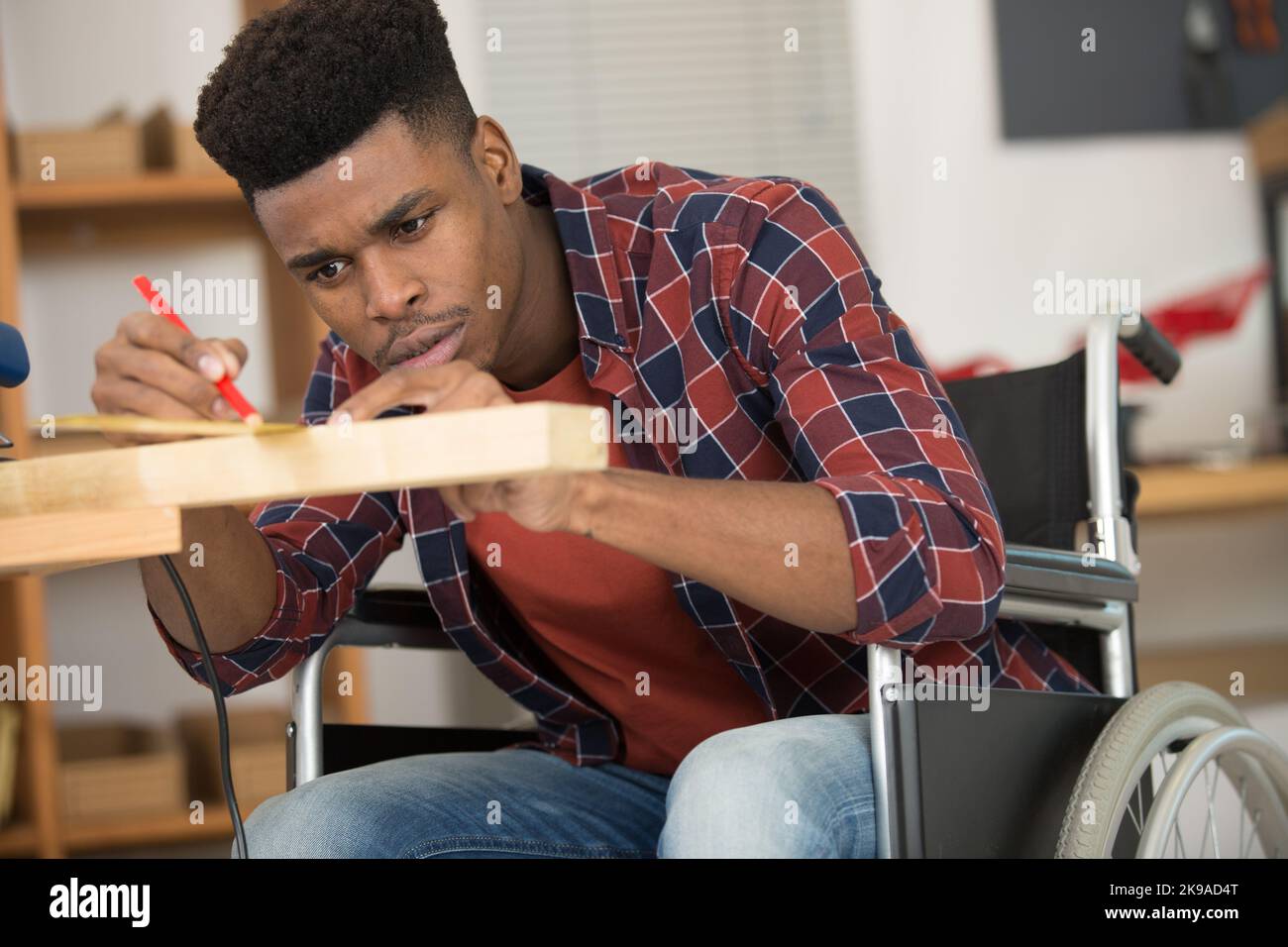 disabled man working with wood in workshop Stock Photo - Alamy