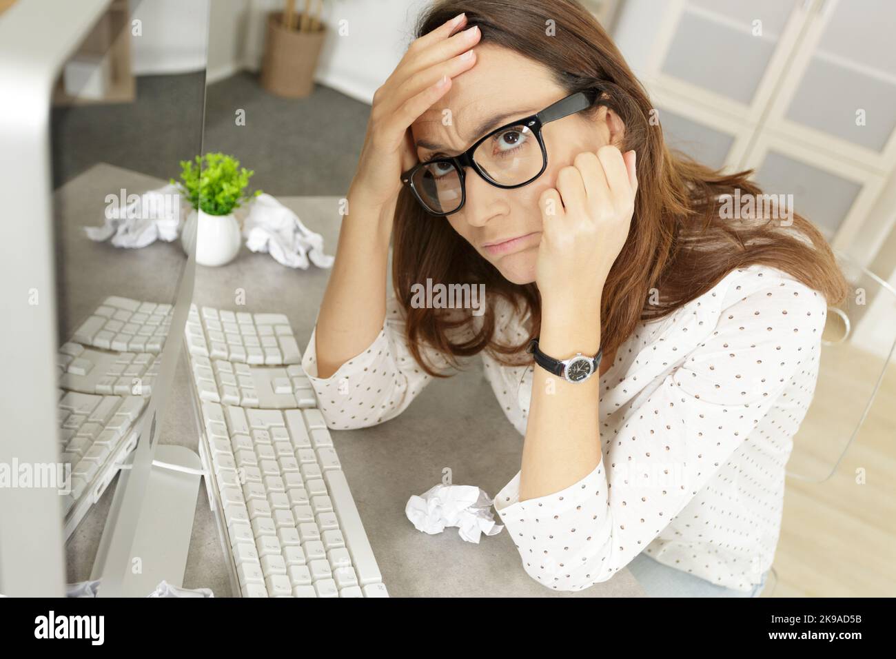 desperate employee in her office Stock Photo - Alamy