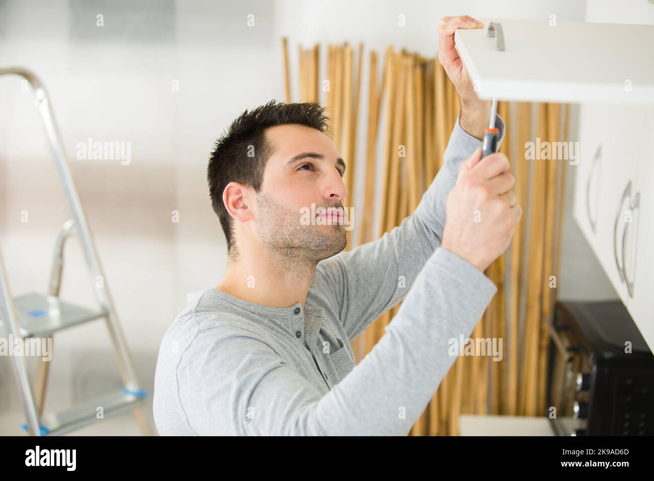 man mounting the cupboard door Stock Photo - Alamy