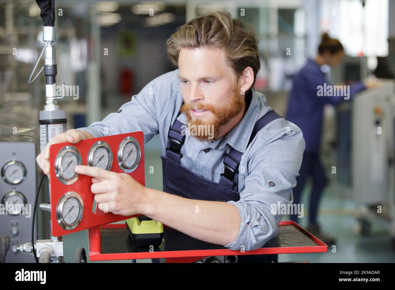 man pointing at machine valves Stock Photo - Alamy