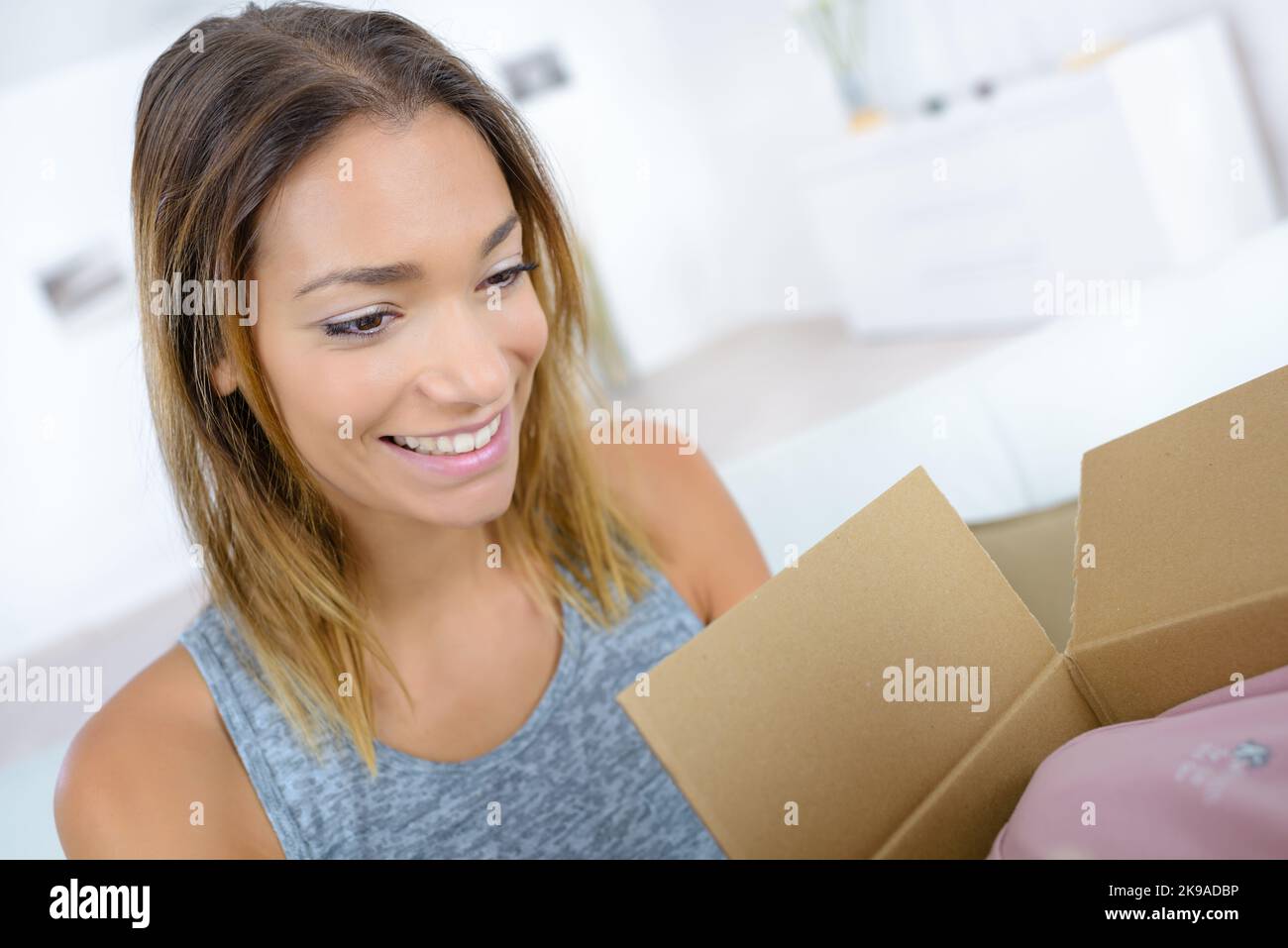 a woman opening a box Stock Photo - Alamy
