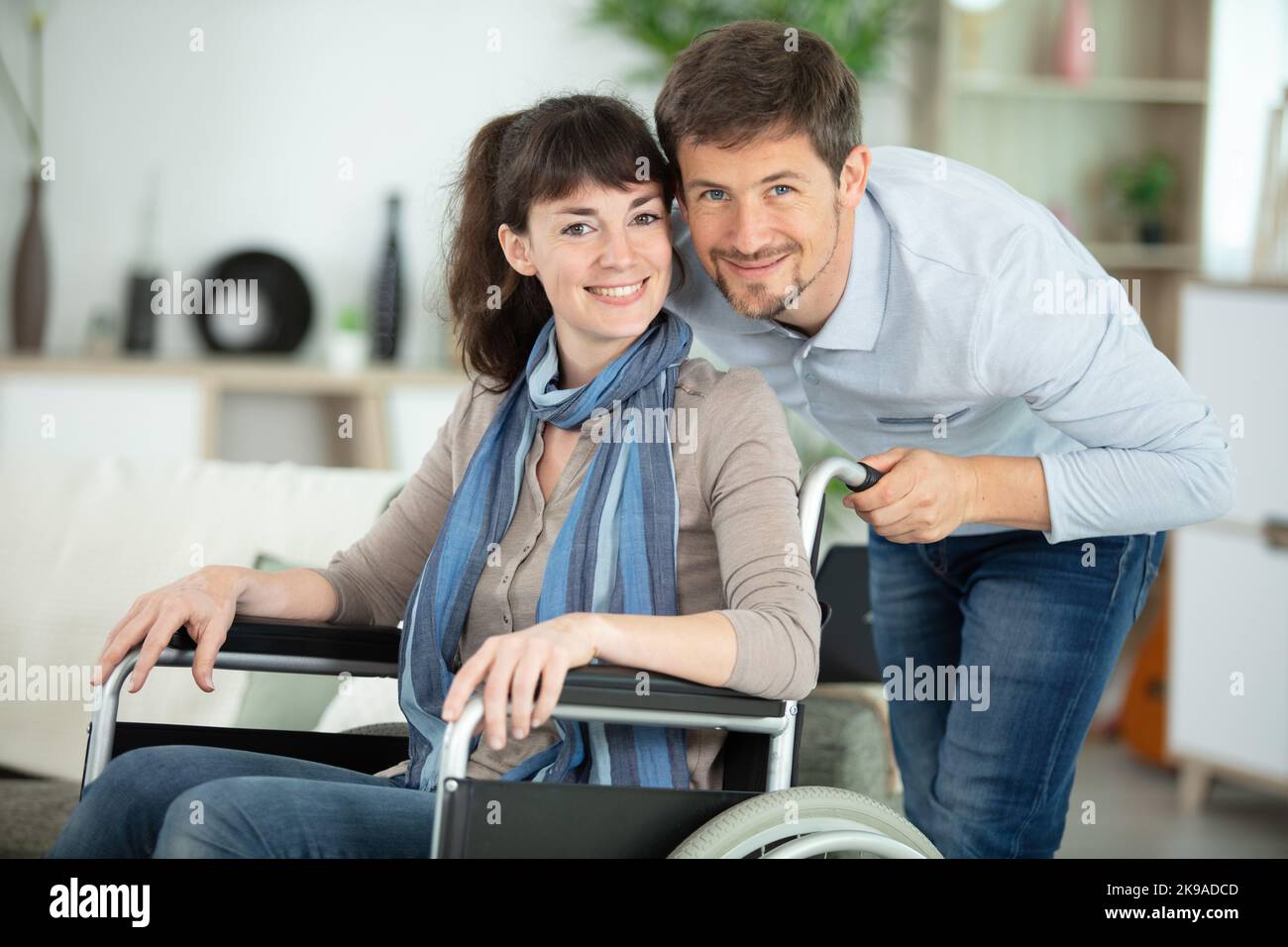 handicapped young woman in wheelchair and her husband at home Stock ...