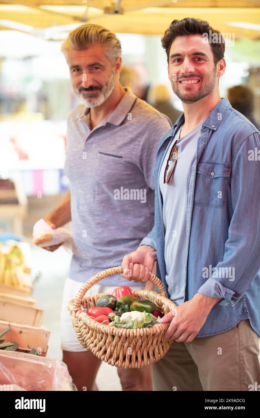 a couple of men shopping in the market Stock Photo - Alamy