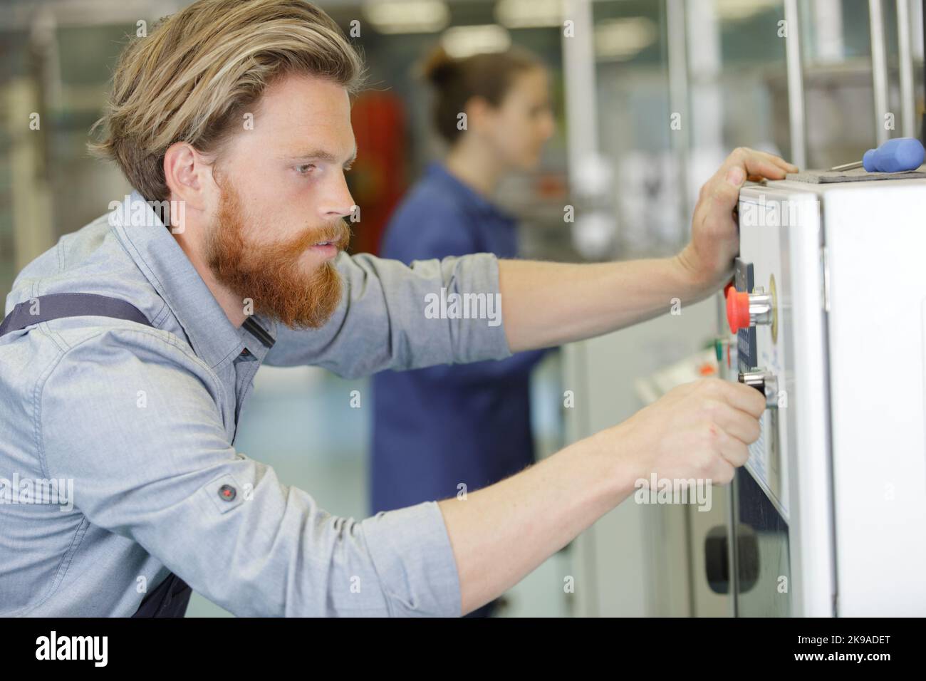 worker operating machine in factory Stock Photo - Alamy
