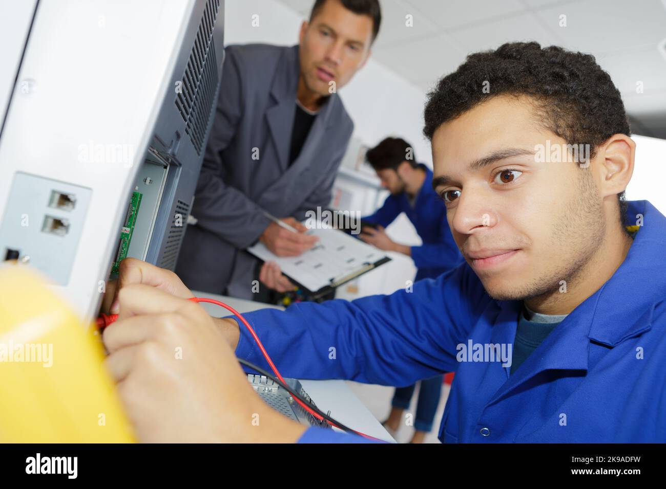 Young technician using multimeter hi-res stock photography and images ...